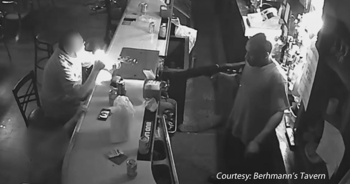 Man in St. Louis bar lights cigarette while ignoring armed robber
