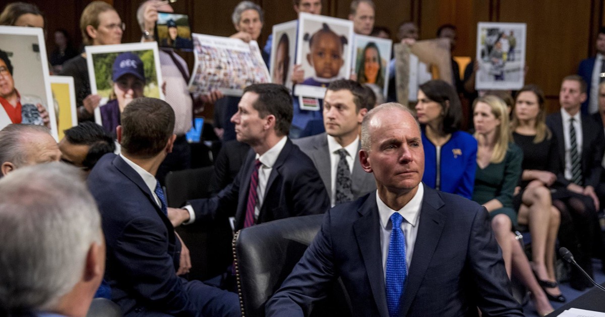 Relatives of Boeing 737 Max crash victims hold up pictures of loved ...