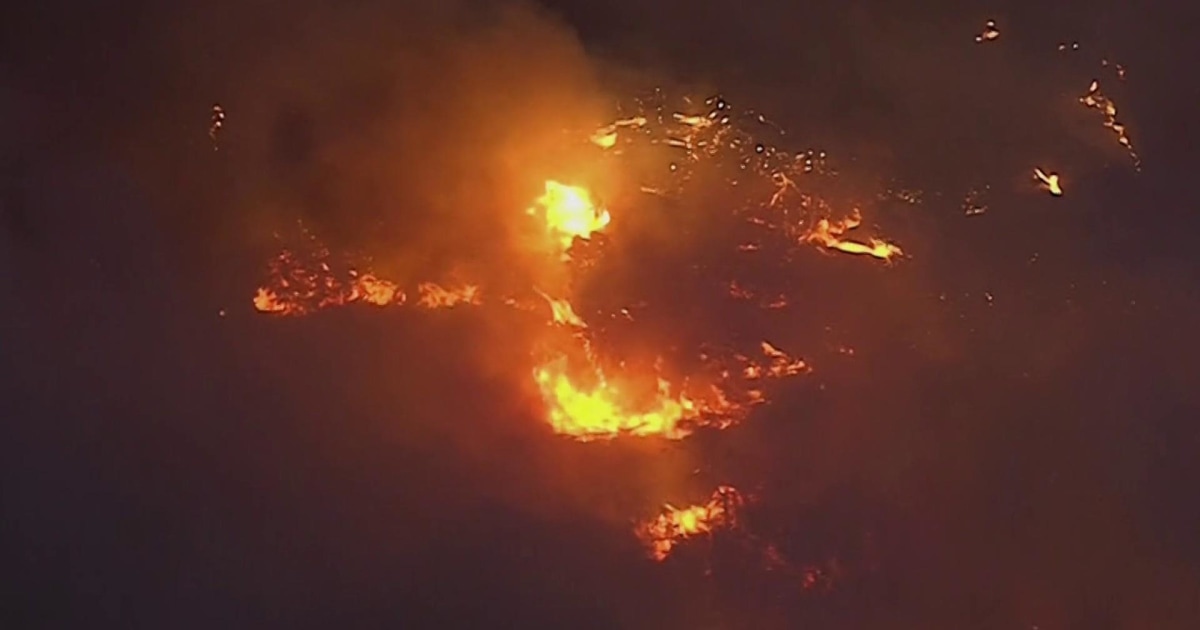 Fires continue to grow in southern California as strong winds persist