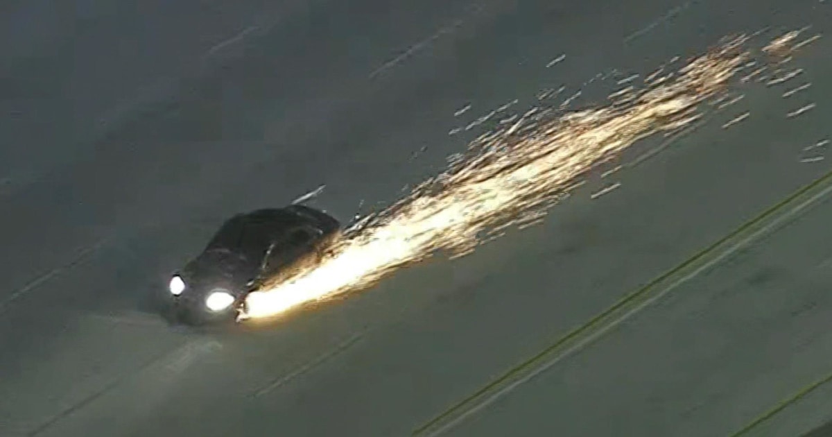 Aerials show intense car chase where sparks fly and driver runs across ...