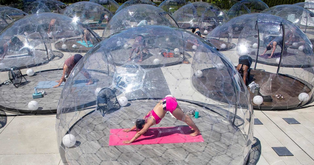 Hot yoga fans use domes to exercise with social distancing