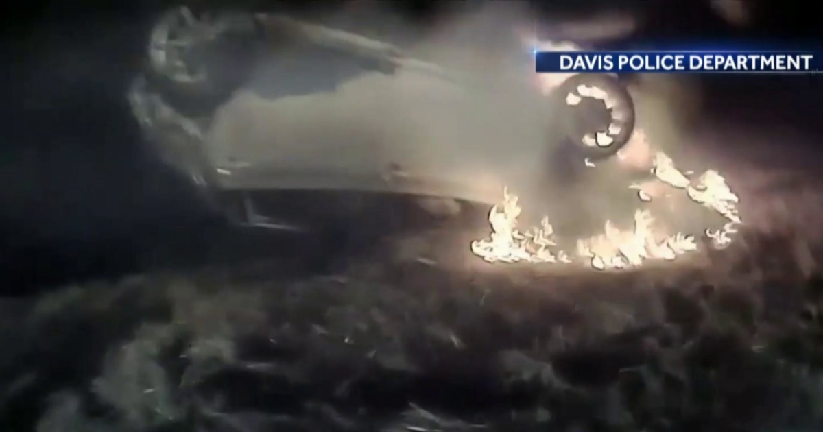 Police officer saves woman from fiery crash in dramatic rescue
