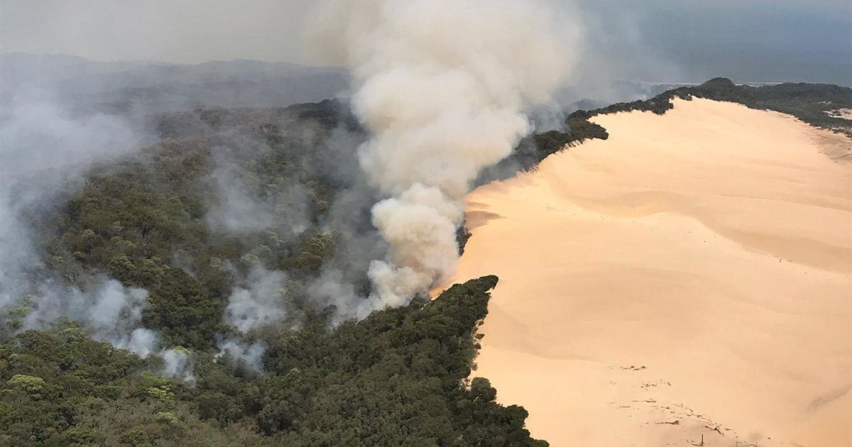 Residents urged to leave as wildfire consumes half of Australian island
