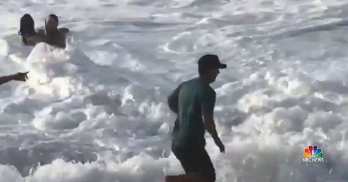 Video captures pro surfer rescuing woman caught in rough waves