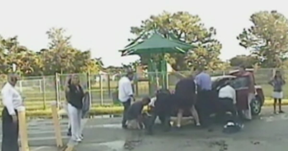 Bystanders lift car to free trapped child