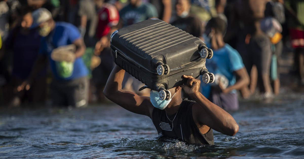 Migrants at Del Rio wade across Rio Grande to Mexico for food, supplies