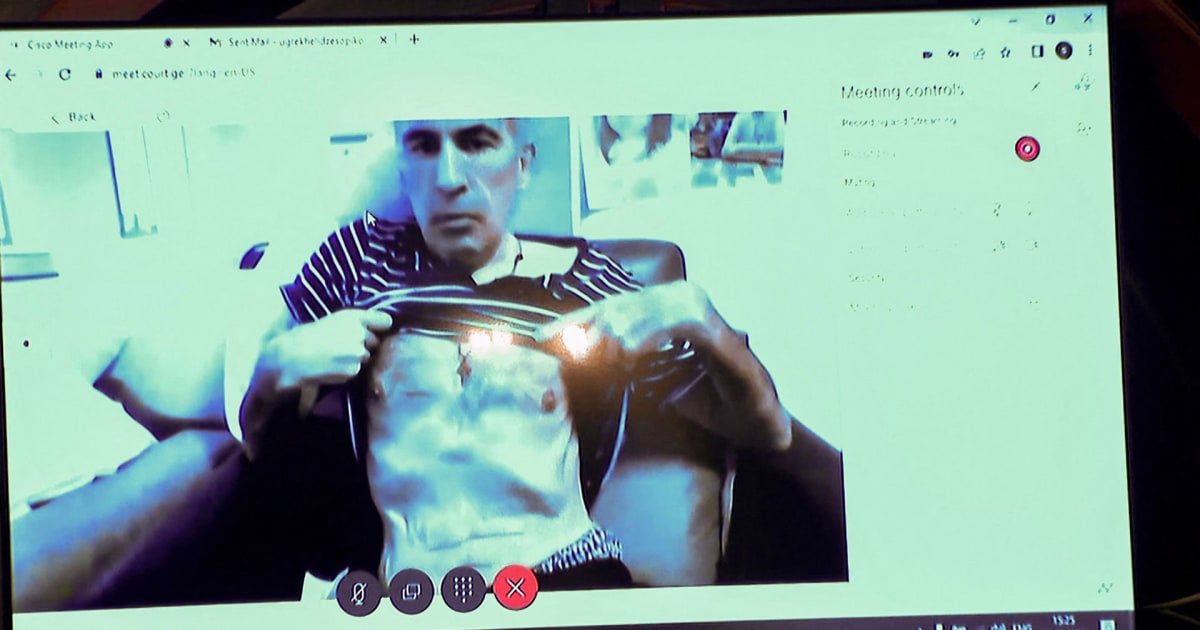 Former Georgian president bares his chest during court appearance