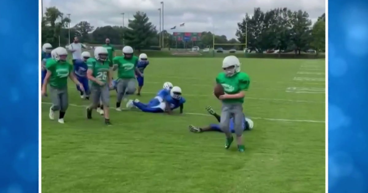 Elementary school football teams come together to set up special play ...