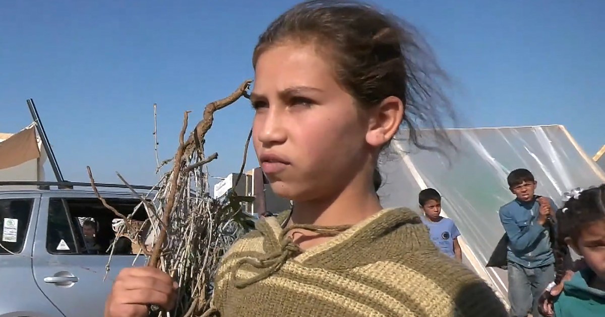 Barefoot Palestinian girl collects firewood at Rafah refugee camp