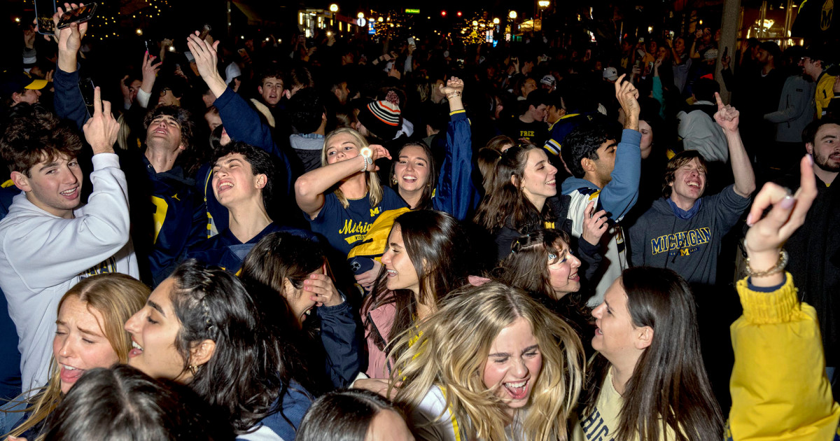 Michigan Wolverines fans celebrate after defeating Washington