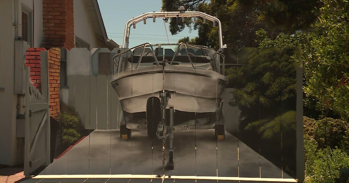 Realistic mural shows boat hidden behind fence in Seaside, California