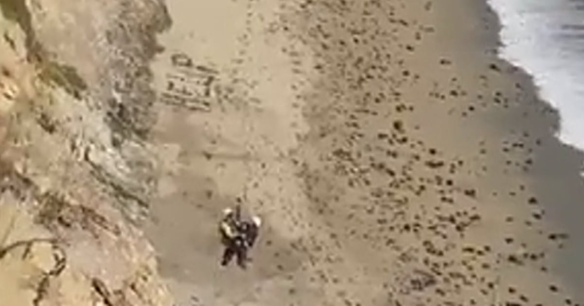 WATCH: Stranded kite surfer is rescued after 'HELP' sign