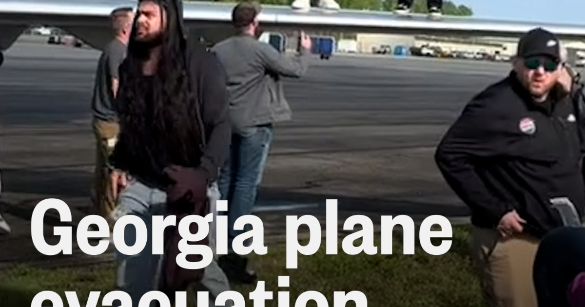 Passengers evacuate off wing of a plane in Georgia
