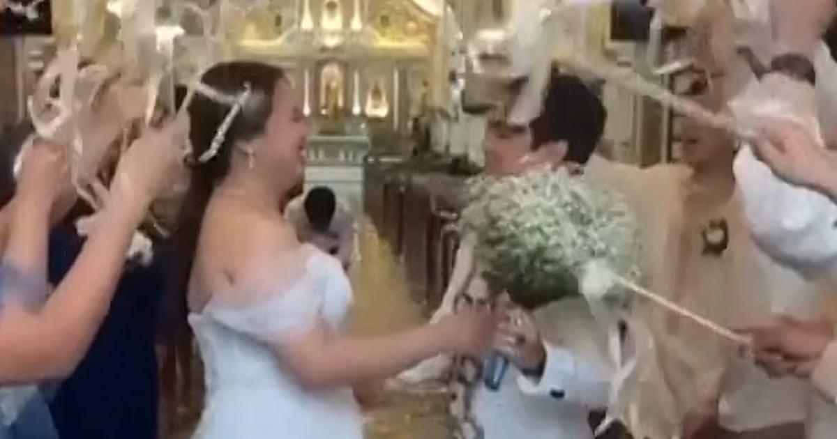 Couple wades down the aisle as flooding hits Philippines