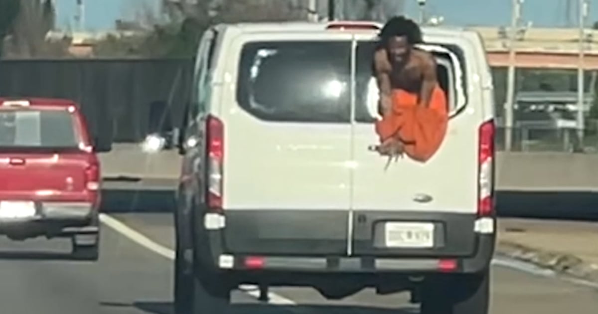 Video shows inmate hanging out of transport van