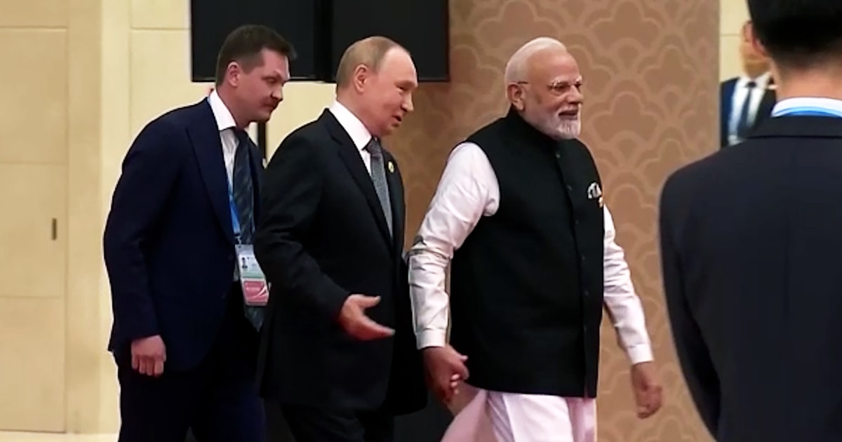 Putin and Modi hold hands ahead of meeting with Xi