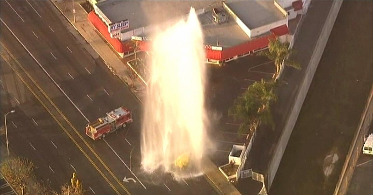 Soaked Firefighters Battle Gushing Hydrant