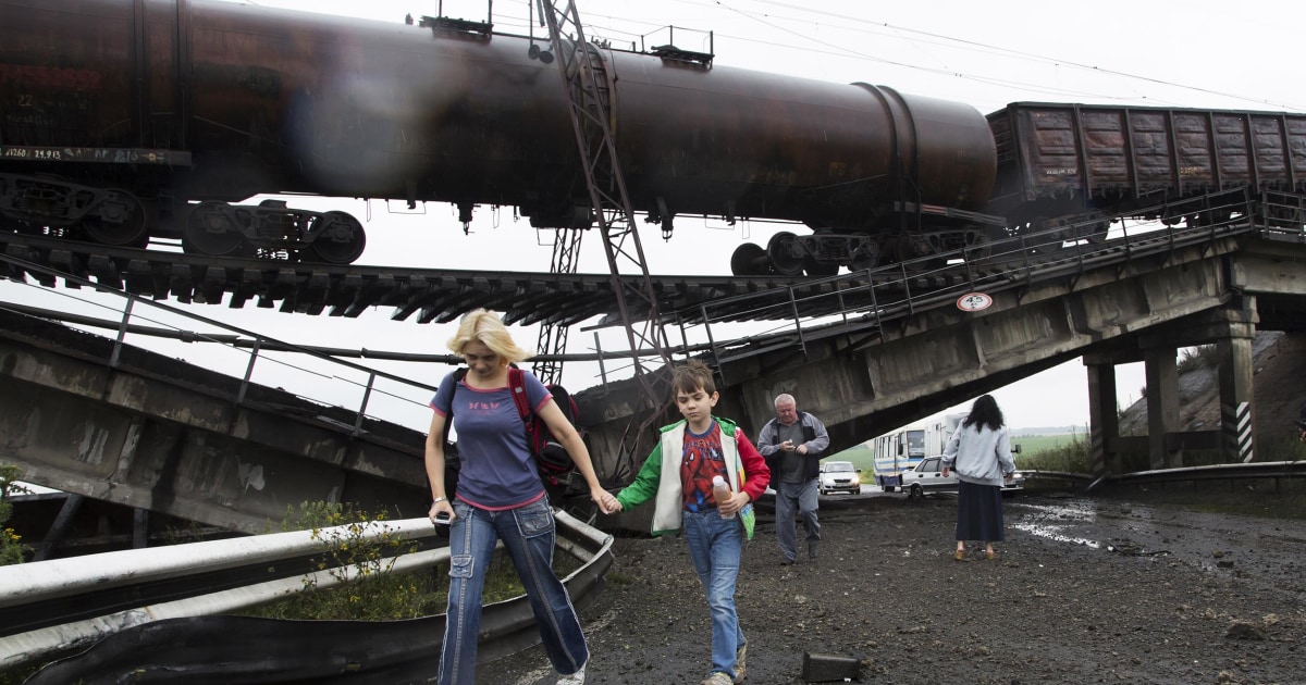Train Hangs Over Road After Explosion Hits Bridge