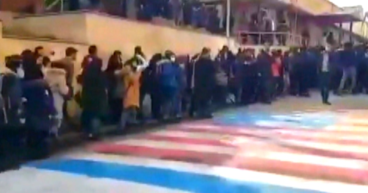 Iran protests: Crowds in Tehran refuse to walk on U.S. and Israeli flags