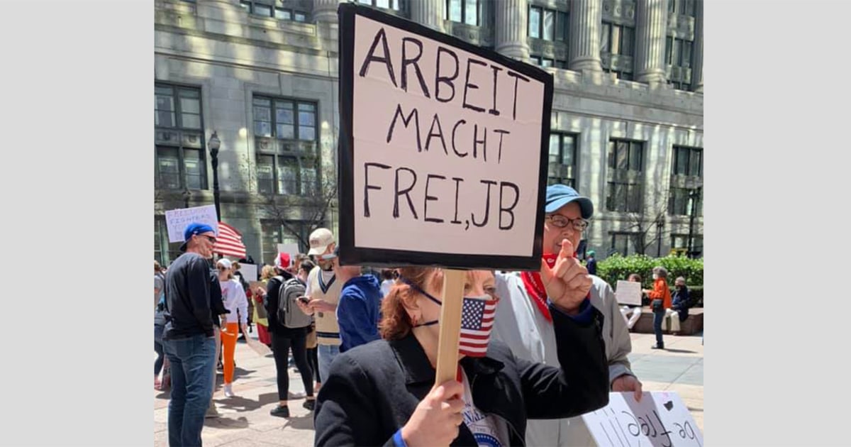 Auschwitz Museum denounces woman holding Nazi sign at Illinois protest