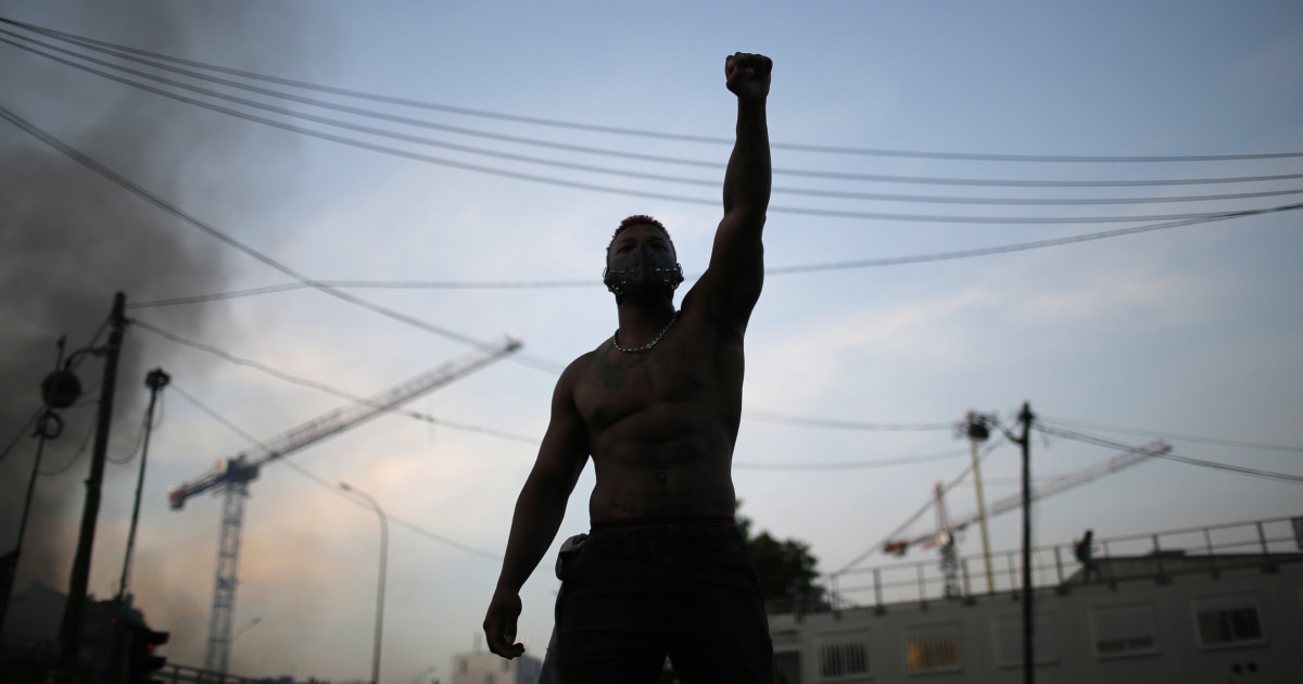 Fires break out as thousands join anti-police violence protest in Paris