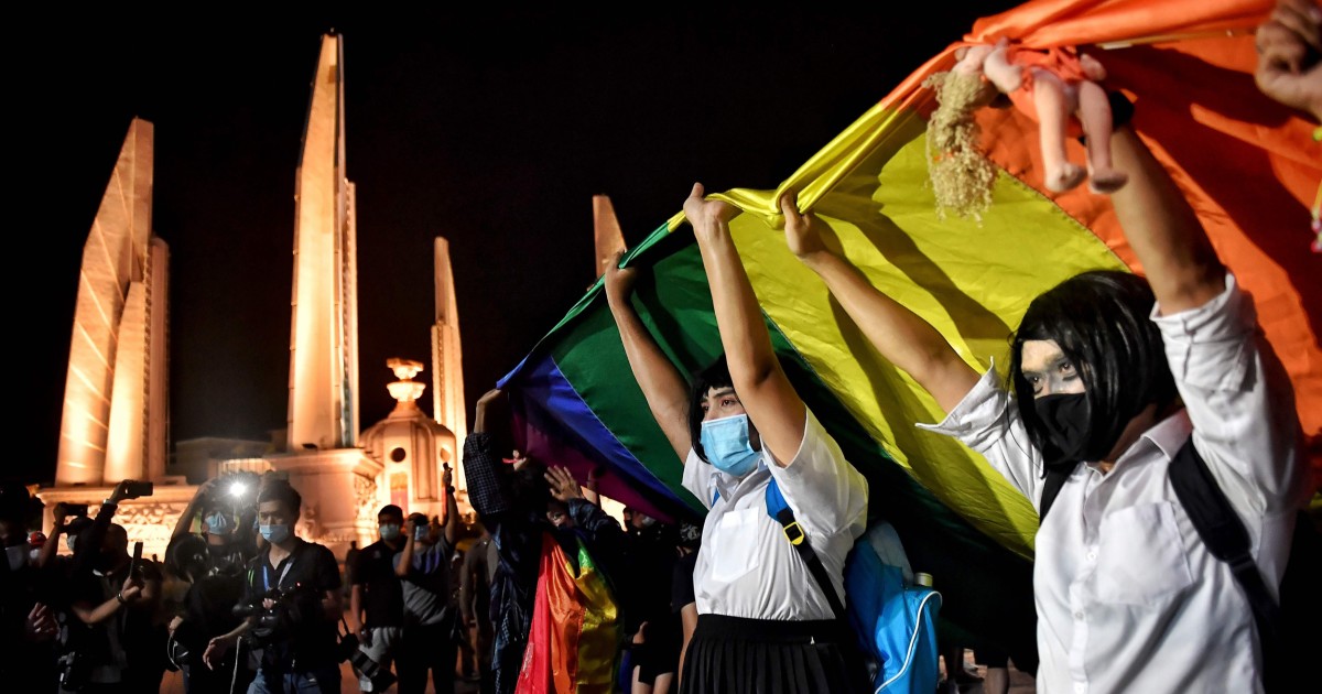 Thai LGBTQ activists raise pride flag in anti-government rally