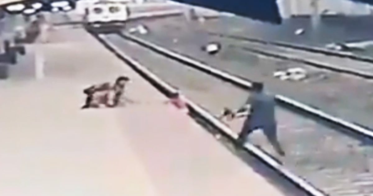 Video shows man rescuing child who fell onto train tracks as oncoming ...