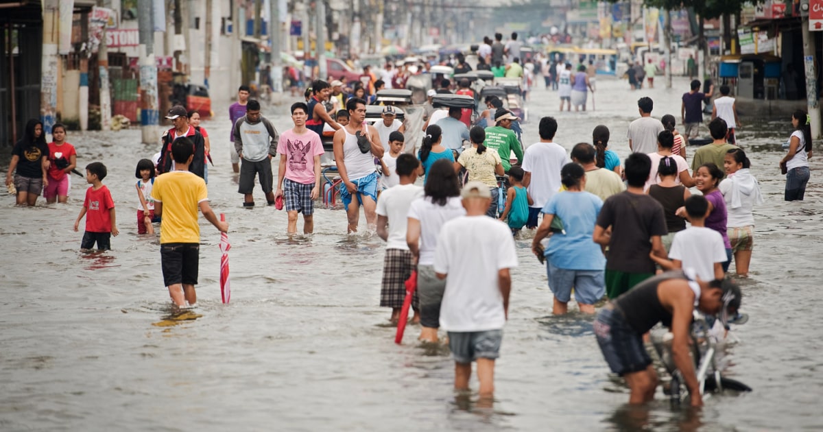 Waiting, wading and mourning in flood-stricken Philippines, as death ...