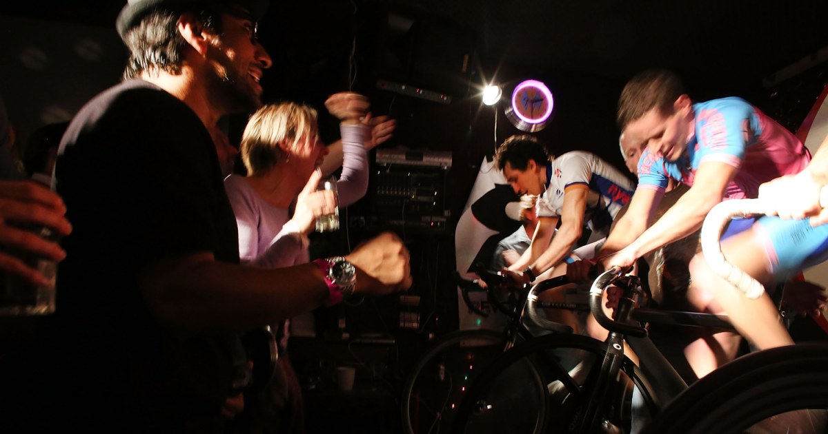 Stationary cyclists race inside NYC bar