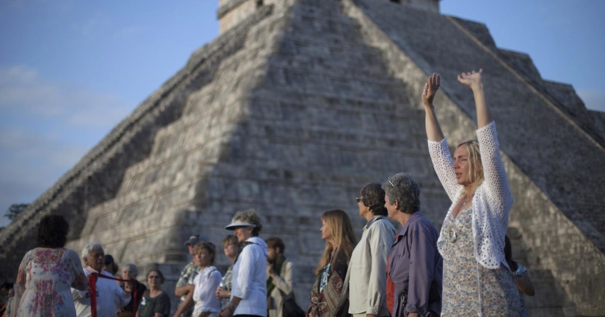 No gloom or doom as crowds usher in new age at Maya monument