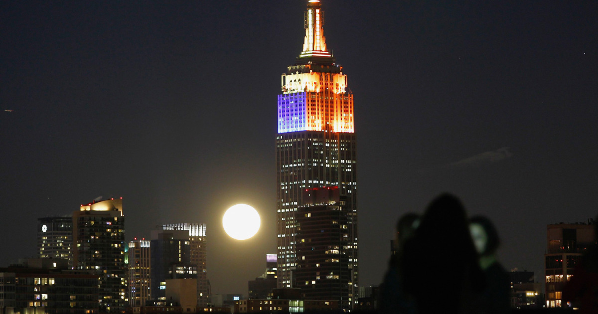 Full moon rises near the Empire State Building