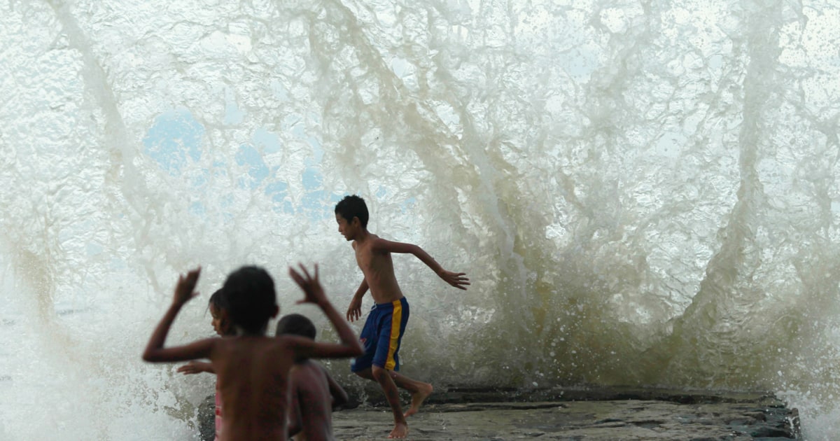 Splashing fun along a sea wall in East Timor