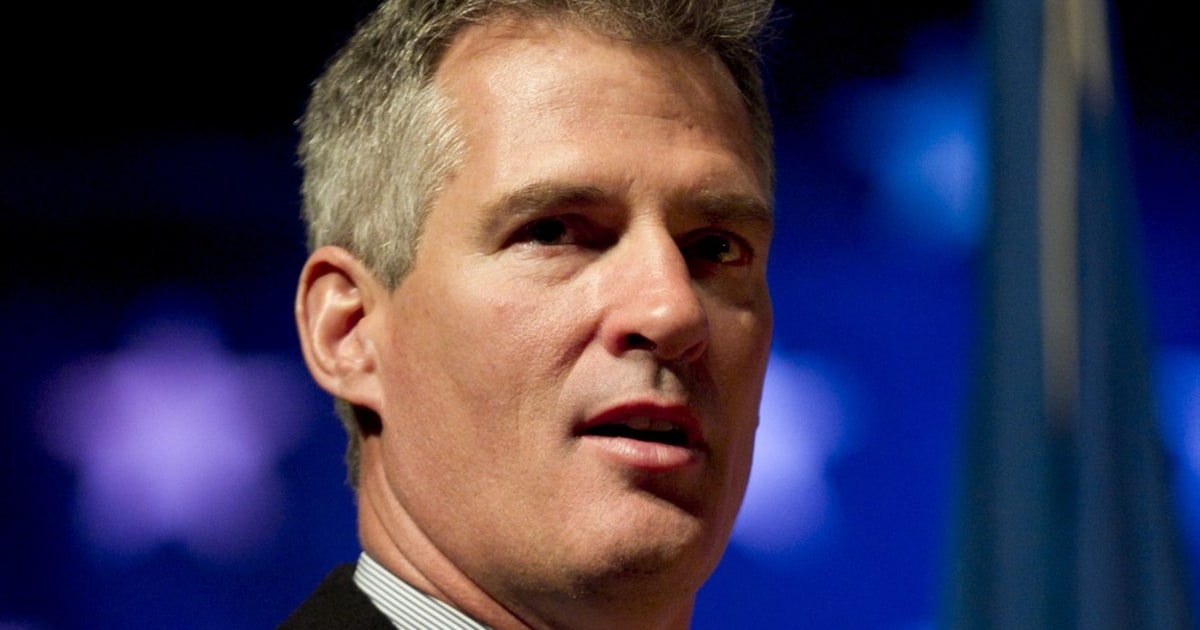 Scott Brown cites pride in 'standing with President Obama' in ad