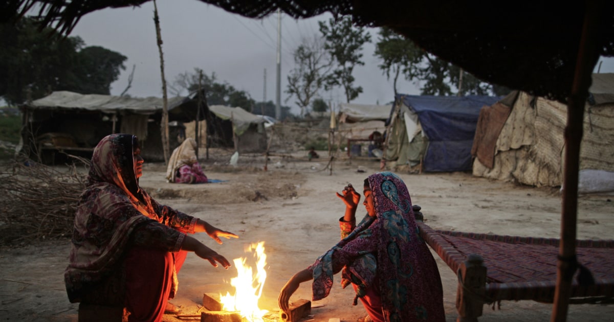 Keeping warm by a small fire in Pakistan