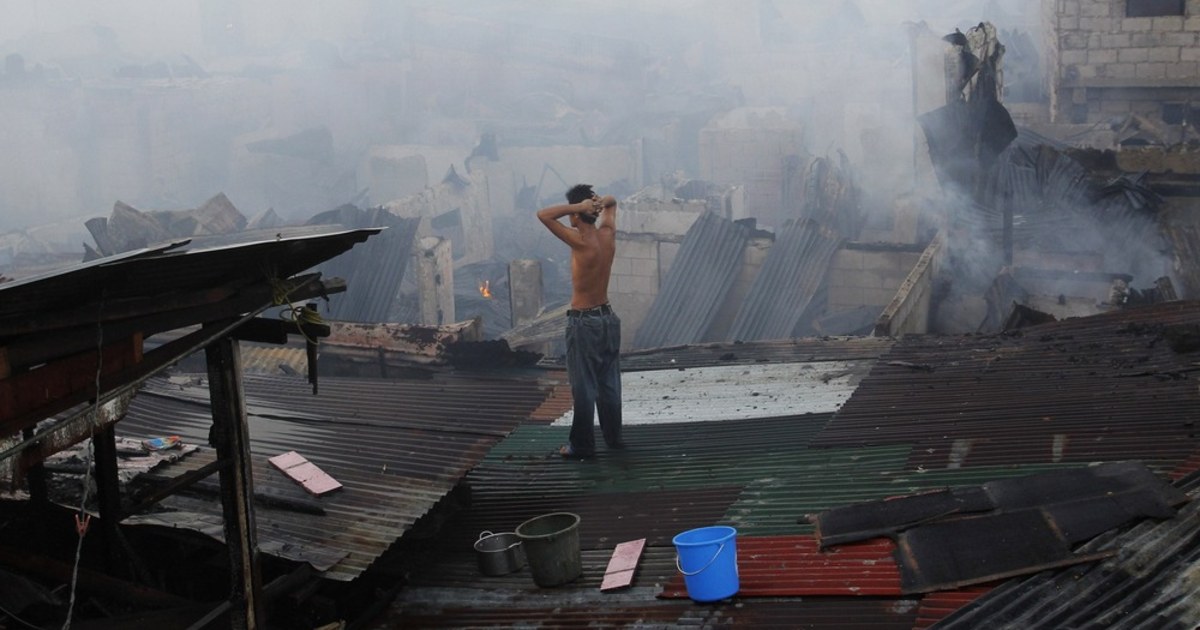 Surveying the damage after a fire in the Philippines