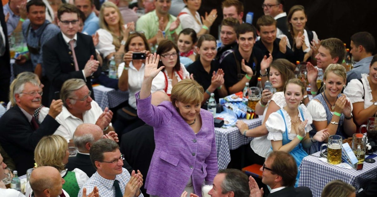Angela Merkel drinks a very large glass of beer