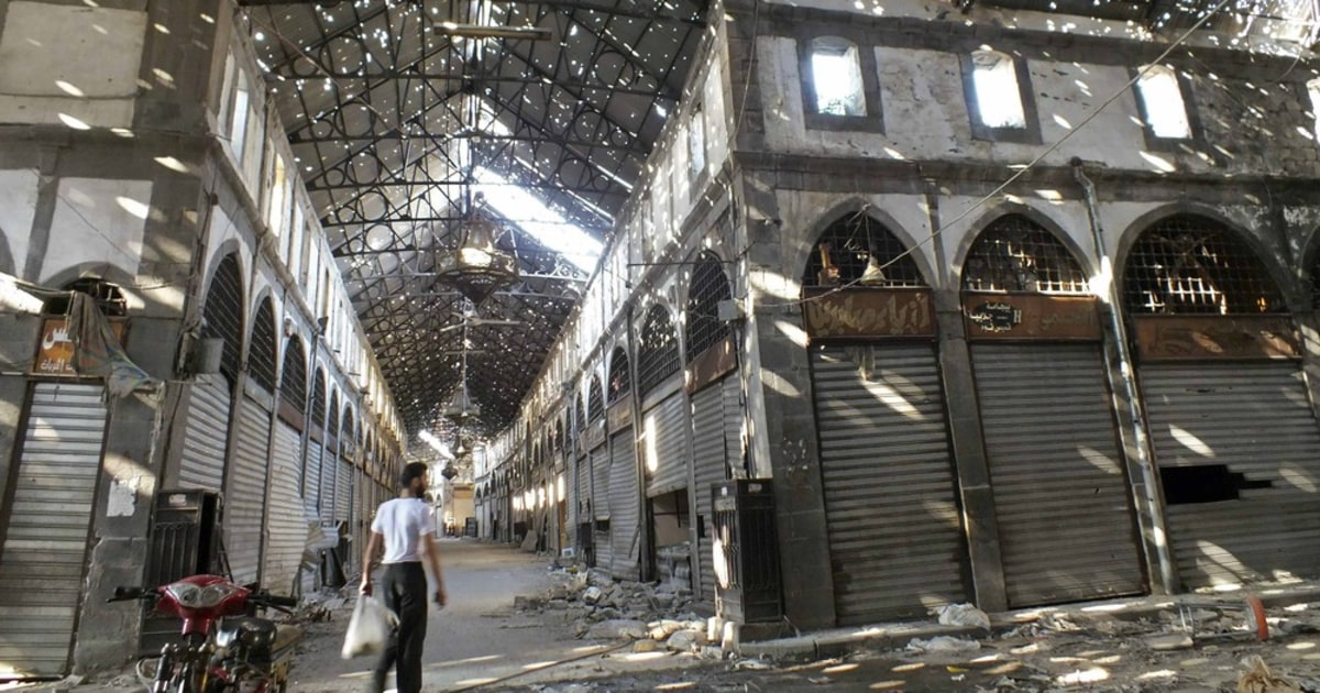 Light leaks through a historic souk roof shredded by Syrian conflict