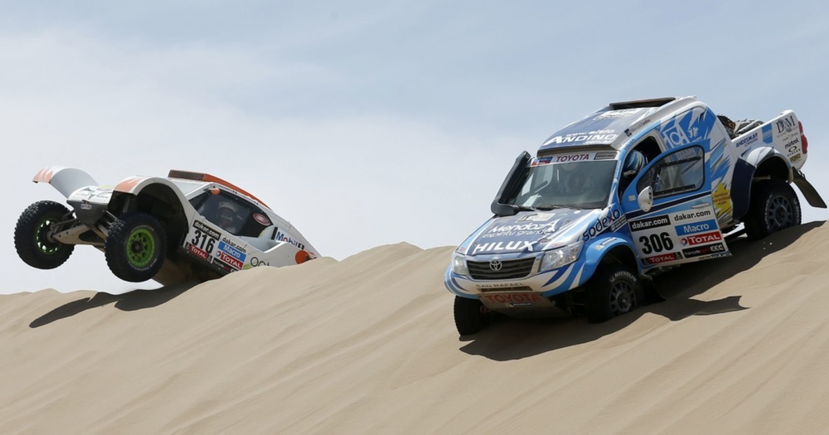 Competitors get stuck in, and escape, the sand dunes on Stage 6 of the ...