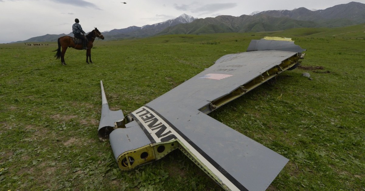 Wrecked refueling plane debris scattered across hillside in Kyrgyzstan