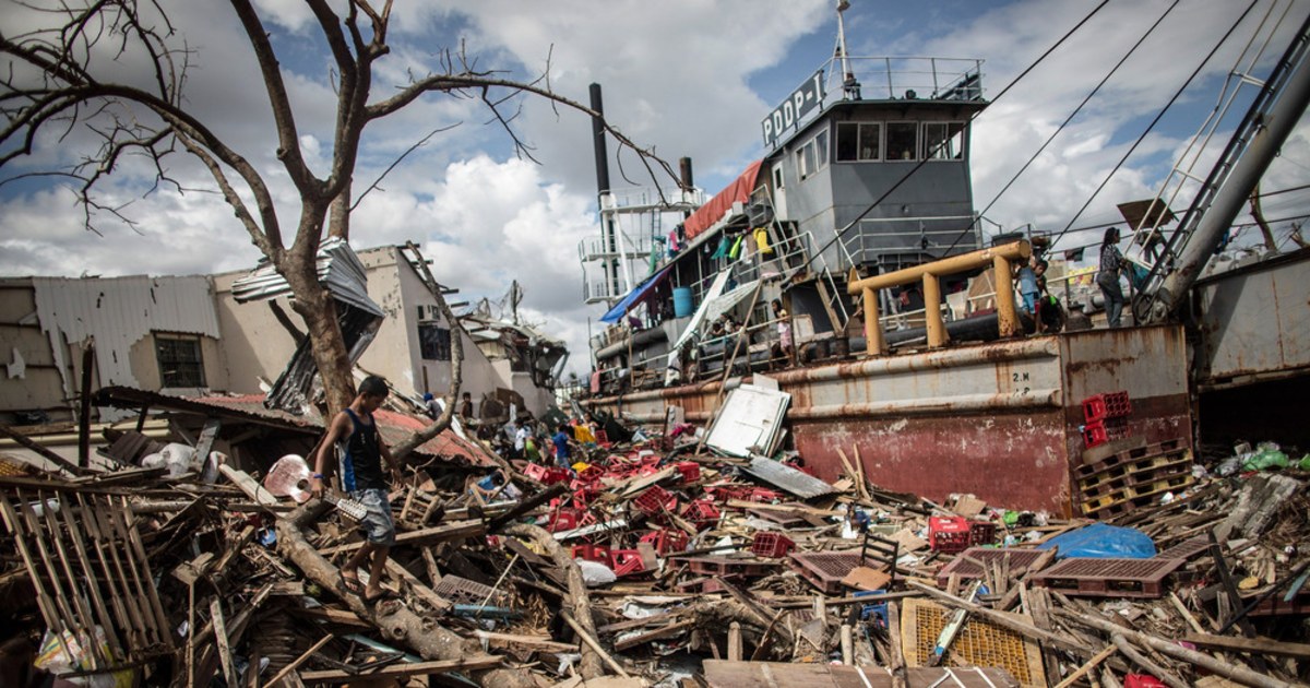 Families take shelter aboard typhoon ship that crushed their homes