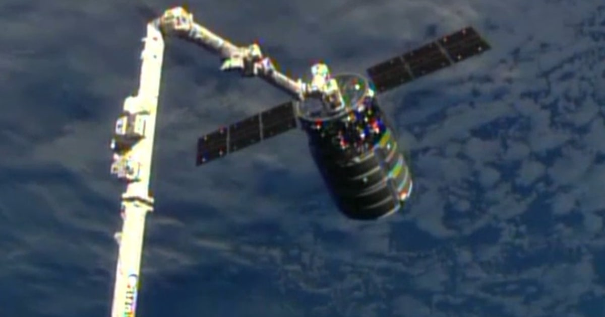 Cygnus cargo craft makes historic hookup with space station