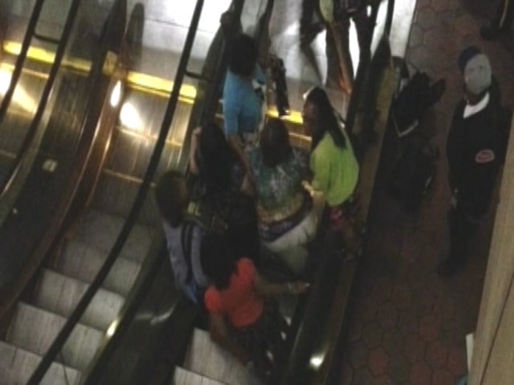 man falls down escalator