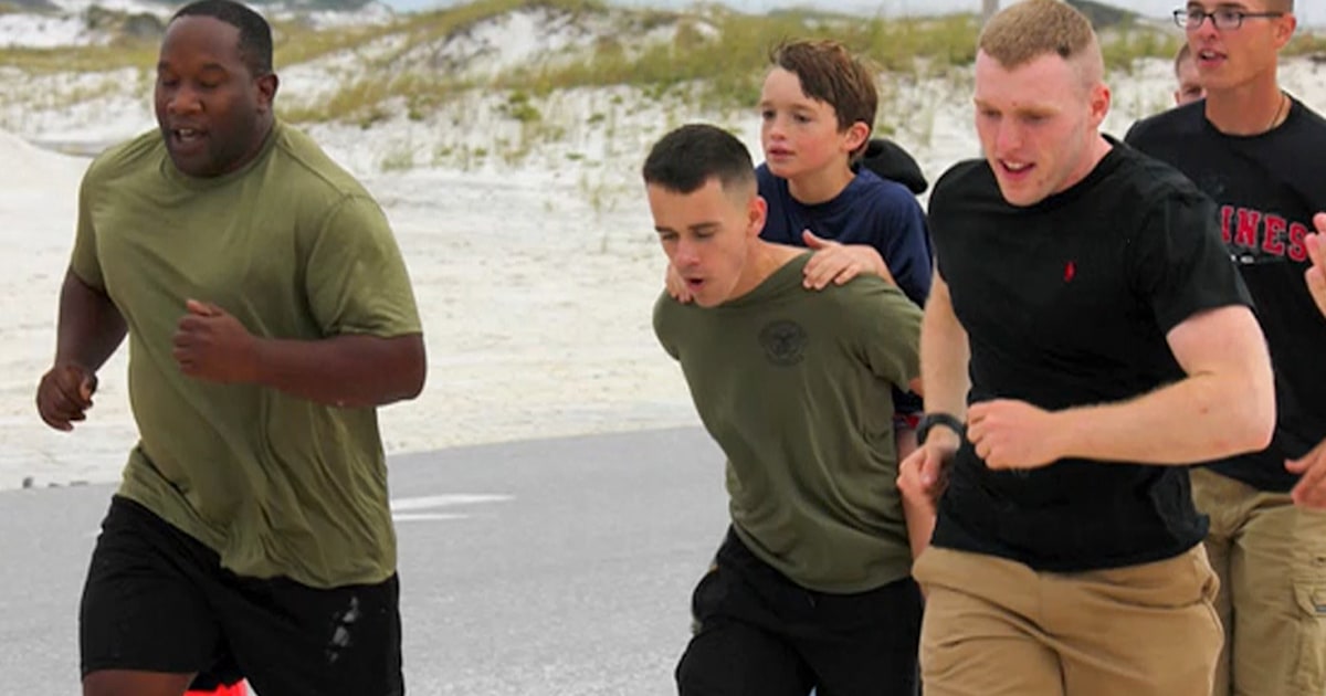 Marine helps cancer survivor, 11, cross finish line