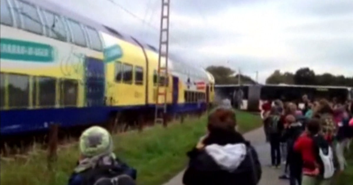 Video: Train slams into school bus as students look on