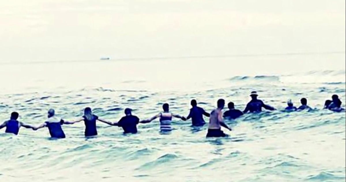 Watch dozens form human chain to rescue stranded swimmers in Florida