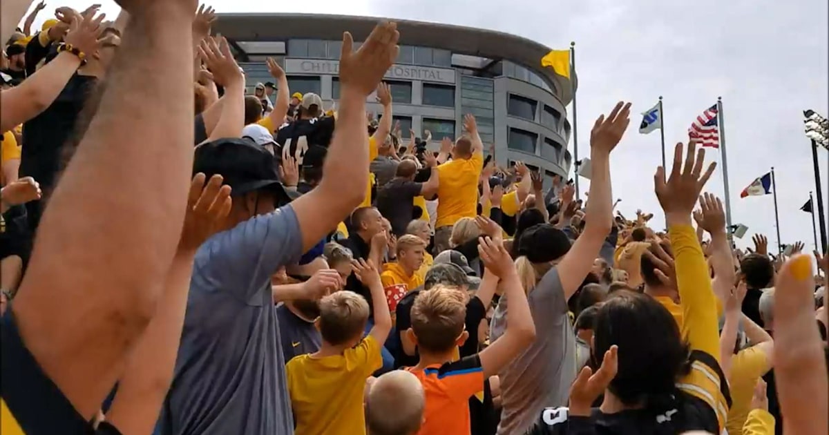 Iowa football fans start heartwarming tradition: Waiving to children’s ...