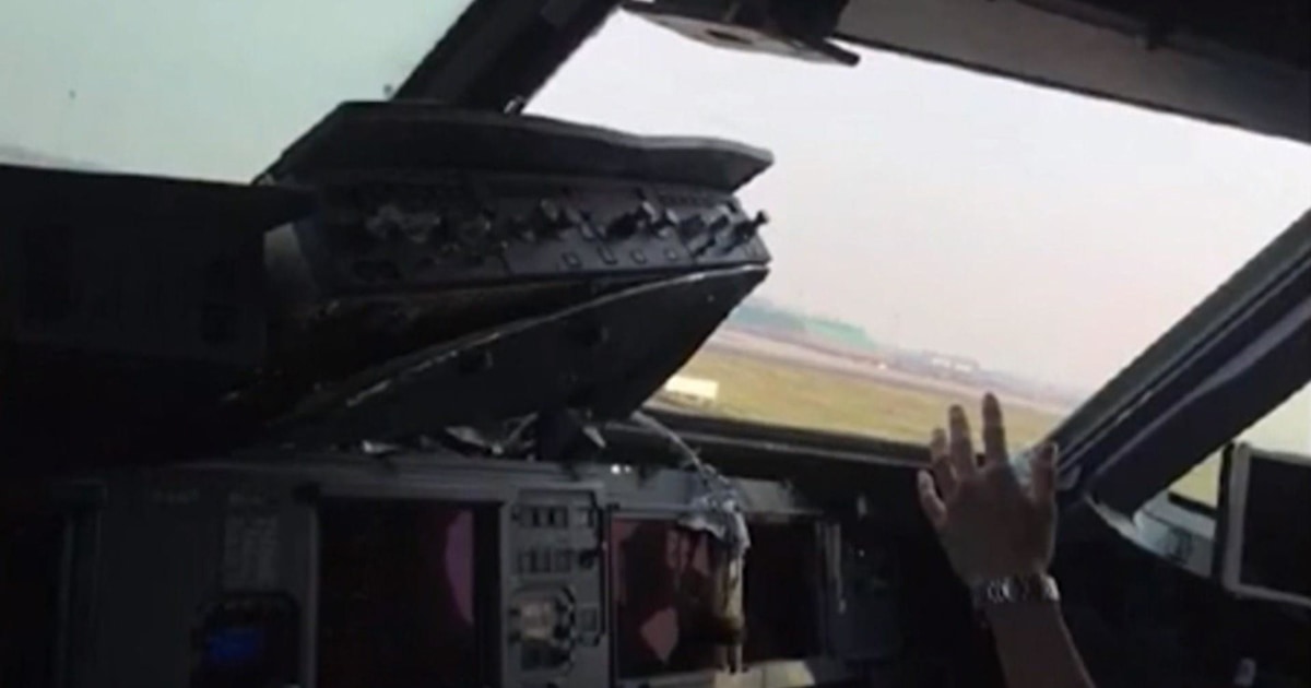 Co-pilot sucked halfway out of plane when windshield cracks mid-flight