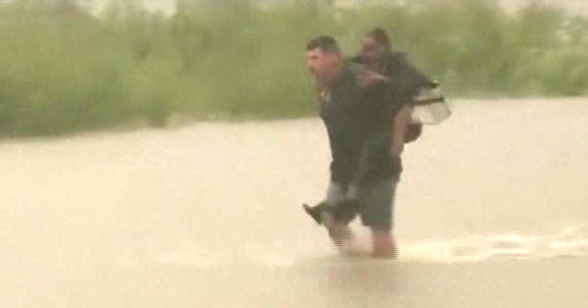Football coach rescues woman stuck in flood