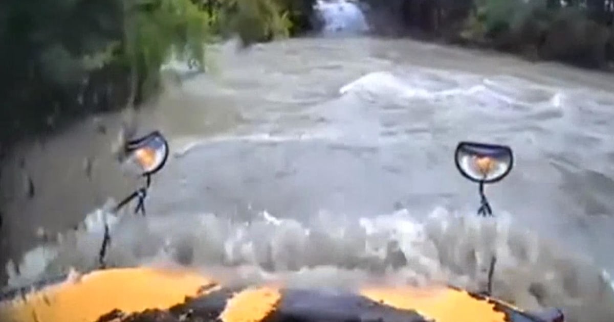 School bus swept away by flooded roadway