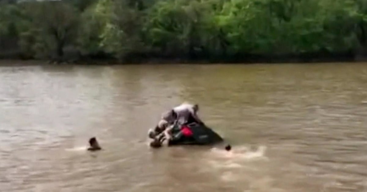 Dramatic video shows strangers diving into river to save trapped driver
